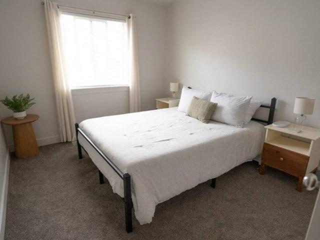 The bedroom includes a comfortable queen