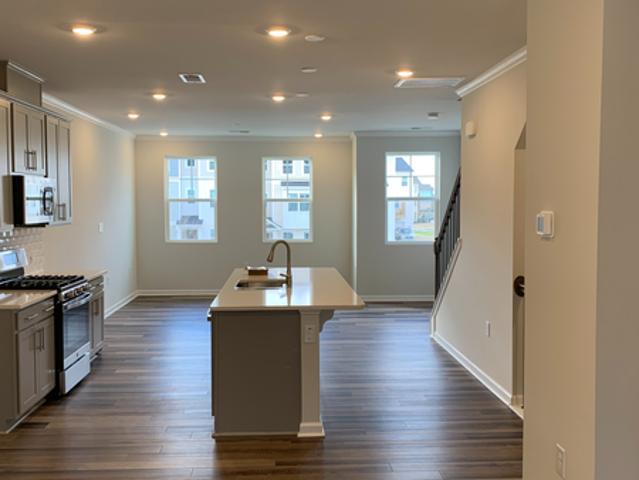 The multifunctional kitchen features brand new stainless steel appliances, a generous center island and lots of cabinetry storage to help keep things organized. Open concept design allows for seamless flow between the living and dining spaces.
