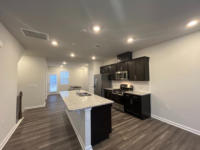 The multifunctional kitchen features brand new stainless steel appliances, a generous center island and lots of cabinetry storage to help keep things organized. Open concept design allows for seamless flow between the living and dining spaces.