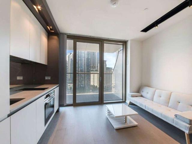 The studio apartment itself boasts an open plan layout, providing a seamless flow between the living, dining, and sleeping areas