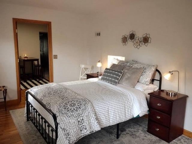 The room features a mini refrigerator