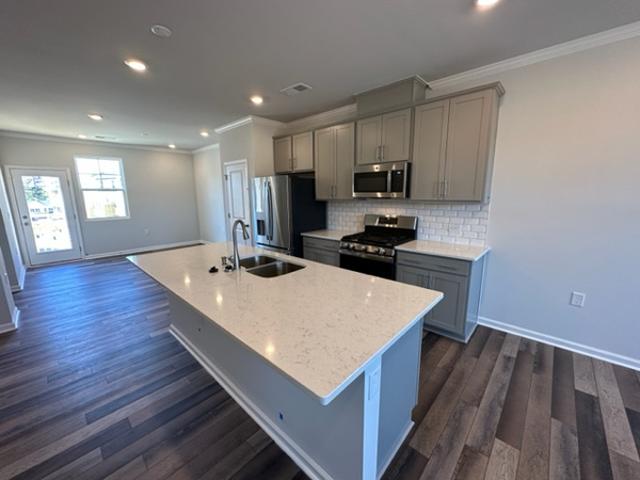 This new three story townhome is designed for ease and comfort, with a secluded first level bedroom. The second level has an open plan main living area and a deck for sipping sweet tea.