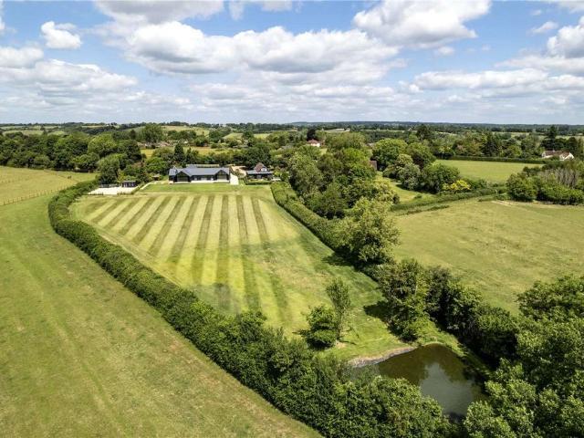 This exceptional new build 5 bedroom, 5 bathroom luxury residence offers spacious, high specification living. Set within 2.6 acres, it enjoys far reaching views and a tranquil rear pond
