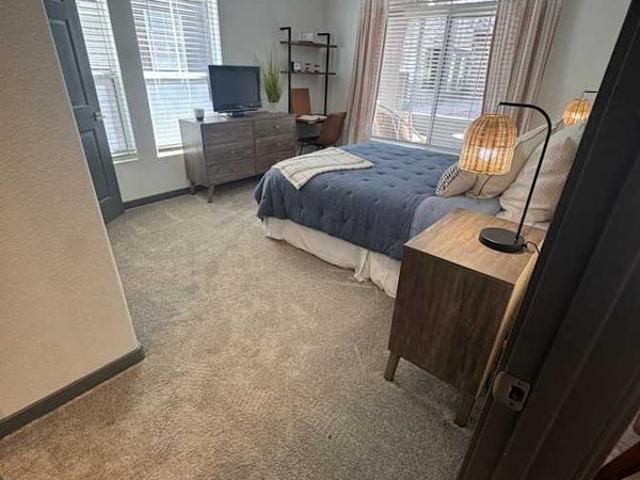 Unfurnished master bedroom with attached bathroom