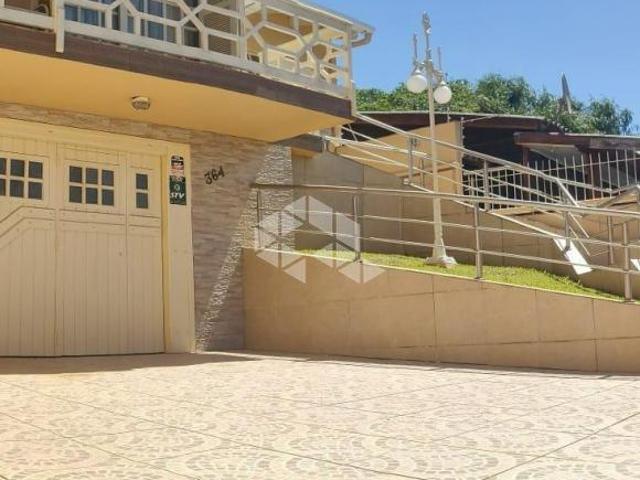 VENDE SE CASA DE 3 DORMITORIOS 2 VAGAS DE GARAGEM EM VIAMÃO
