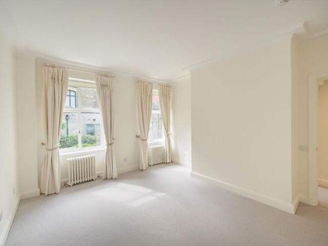 A magnificent family townhouse overlooking Kensington Gardens in one of London's most prestigious addresses, with private garden and parking, set within a peaceful cul de sac