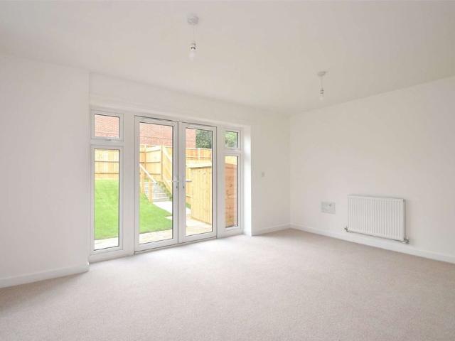 A modern three bedroom family home with private garden and parking
