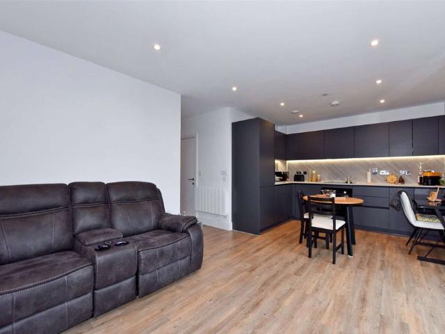 A modern apartment with south facing balcony offering far reaching views in the sought after Horlicks development by Berkeley Homes