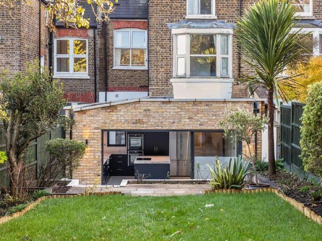A modern, bright four bedroom property with a private garden, terrace and studio