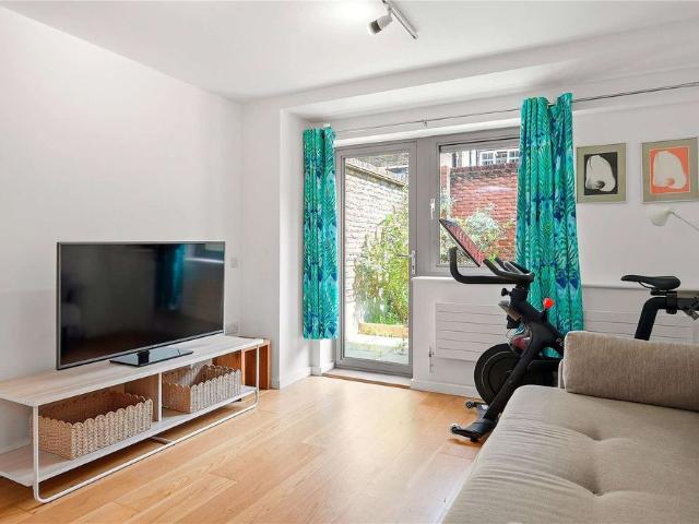 A modern one bedroom apartment with a private patio garden