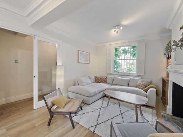 A beautifully presented three level home with a garden in a secluded Chelsea setting