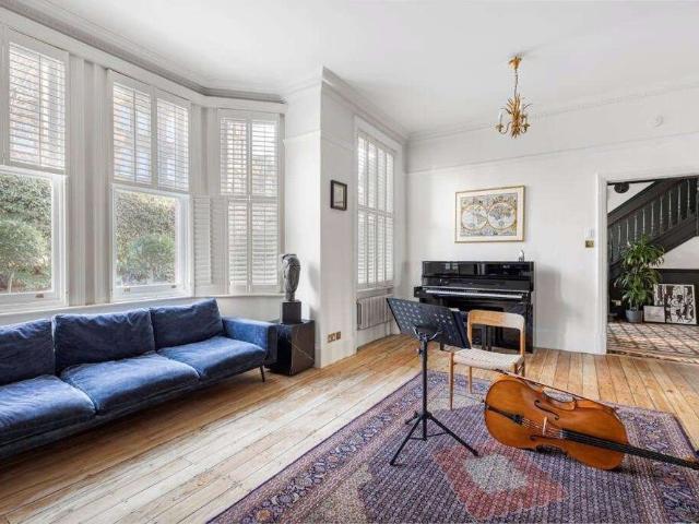 A charming 7 bedroom period house set back from the road behind mature gardens