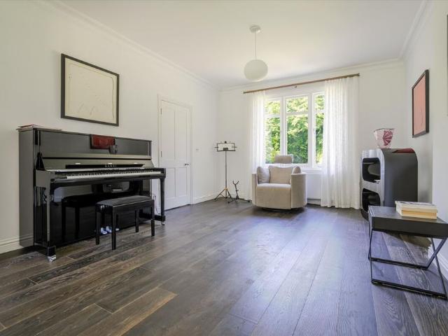 A detached house in Englefield Green set in c.0.5 acre with a heated swimming pool