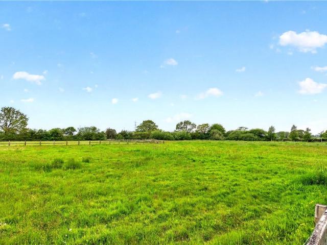 A detached 17th century family home with a double garage, driveway parking and approx. 2.25 acres of land in Mere