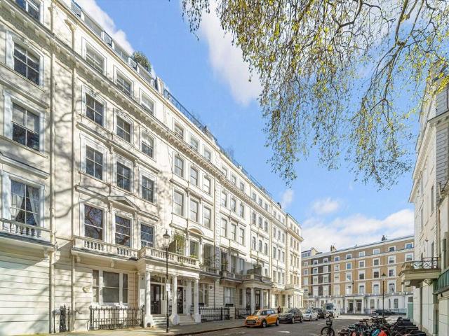 A first floor lateral three bedroom apartment with two balconies in SW7