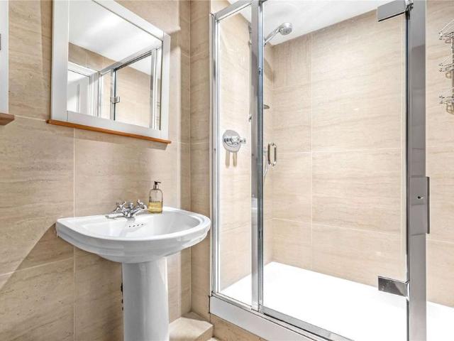 A lovely two bedroom lateral apartment with private patio and communal gardens adjacent to Wimbledon Common