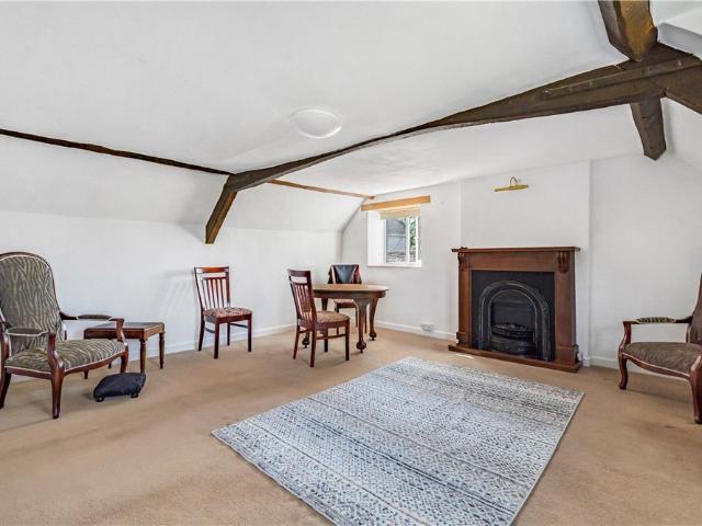 A particularly spacious top floor apartment offers versatile living accommodation and far reaching views over the surrounding countryside