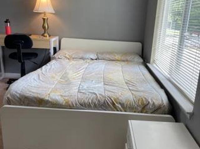 A private room with an attached bathroom and a wa