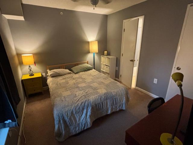 A private room with an attached bathroom and a wa