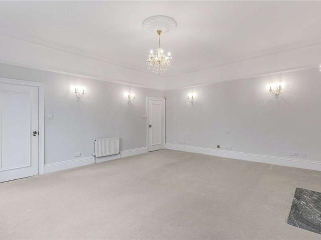 A stunning Grade II listed three bedroom coach house with a lovely patio garden