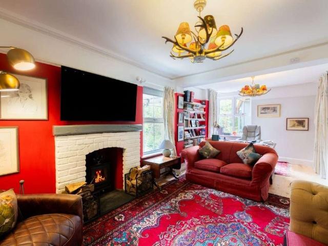 A substantial and beautifully presented four bedroom house, set in an elevated position with valley views. Driveway, large garage workshop with a lift to the li