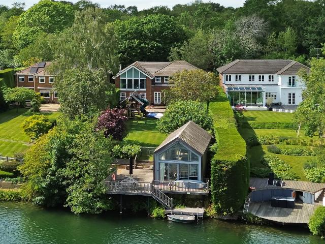 A six bedroom detached family home in Cobham with a boathouse and lake frontage