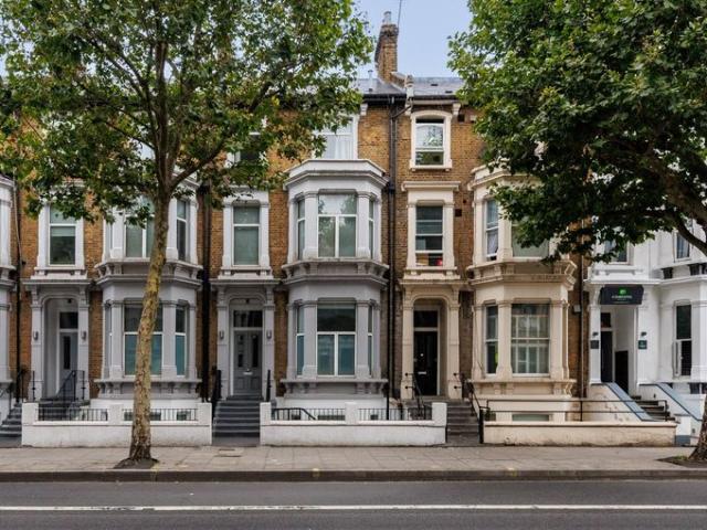 A smart refurbished one bedroom apartment with balcony benefiting from wooden floors, open plan kitchen, bedroom with built in storage and a stylish bathroom