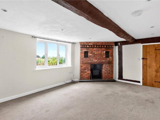 A two bedroom semi detached cottage set with off street parking and a garage in the village of Hopton