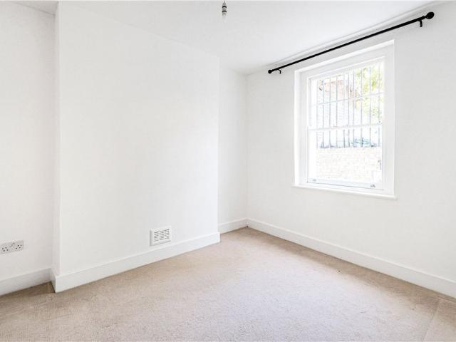 A two bedroom split level flat on the ground and lower ground floor of a converted period property, with access to a private courtyard garden in Camden