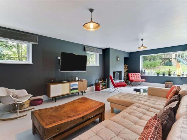 A truly impressive family home in a popular residential road in Esher, offering stylish and modern living with 5 bedrooms, 3 bathrooms and 4 reception areas