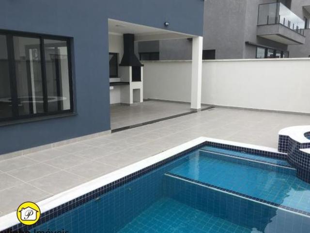 A venda em Peruibe Sobrado NOVO com piscina no Condomínio Flora Rica I, arquitetura moderna, fino a