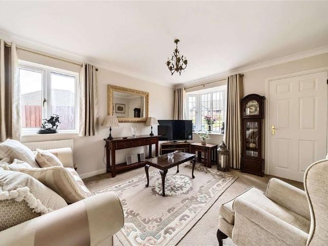 A well presented home with delightful gardens backing onto communal woodland