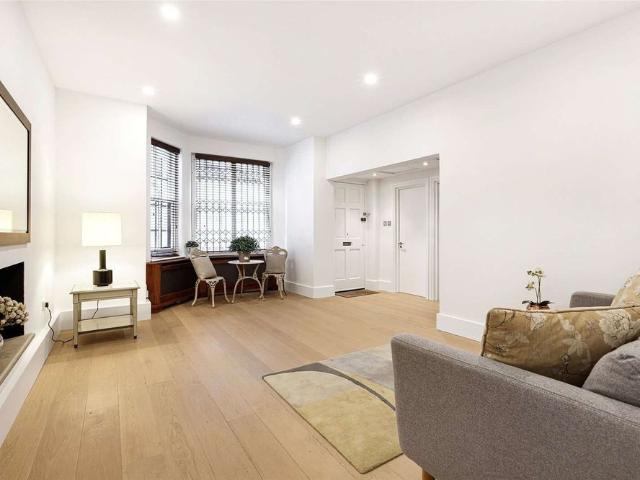 A well proportioned two bedroom lower ground floor apartment with a study