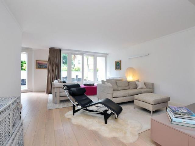 A 3 bedroom apartment with parking, private patio and access to communal gardens