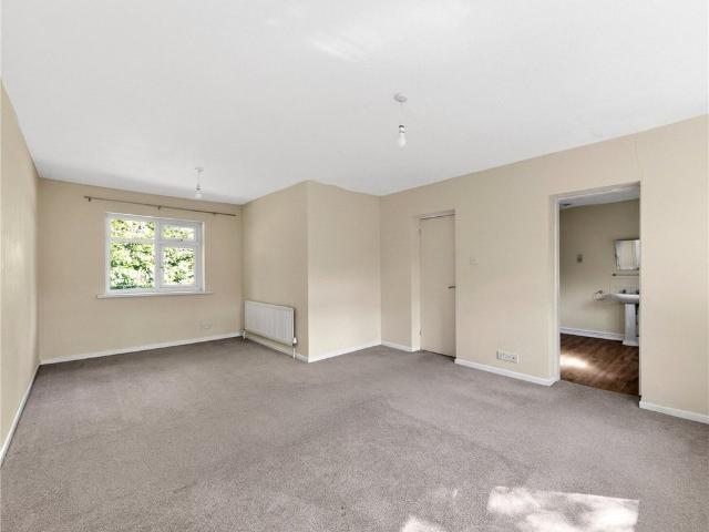 A 4 bedroom detached bungalow on a large plot with parking for several cars
