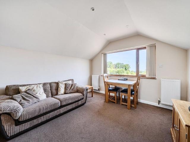 An attractive detached farmhouse providing 5 bedrooms, a separate 1 bedroom holiday let, a detached agricultural building, a large driveway with ample parking, and mature gardens, all situated within open countryside but close to village amenities. Available August