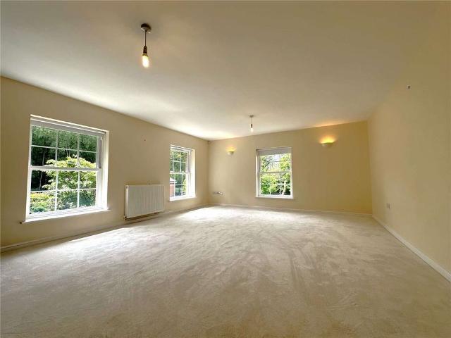 An attractive, well located first floor apartment with allocated parking and communal grounds