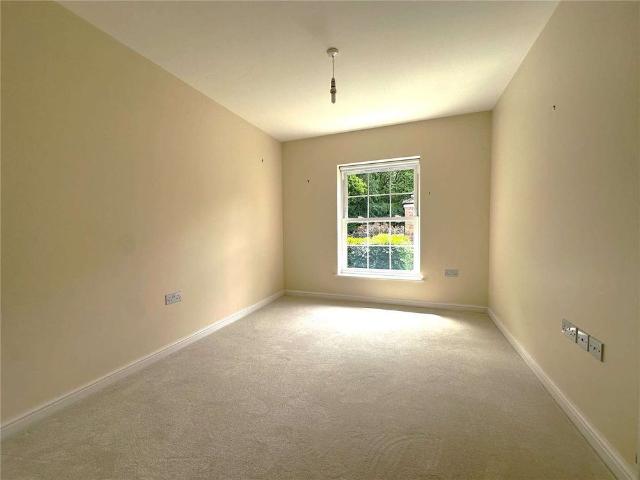 An attractive, well located first floor apartment with allocated parking and communal grounds