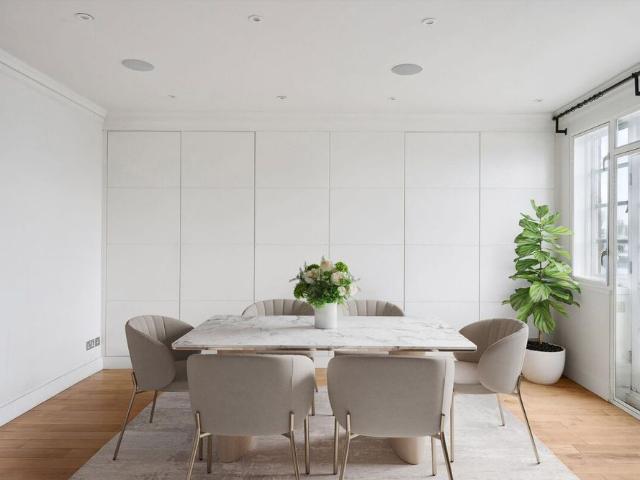 An elegant river facing apartment with a south facing balcony and far reaching Thames views for let in SW3