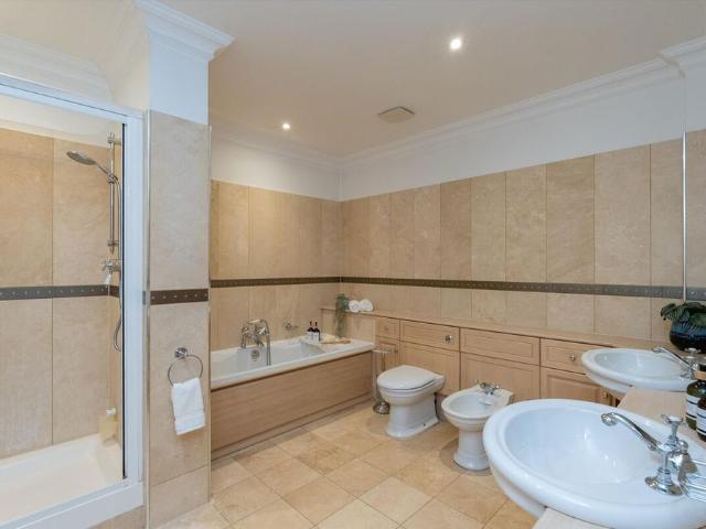 An exceptional 3 bed apartment set within the prestigious, Grade II listed Hatchford Manor, nestled in 11 acres of private parkland featuring beautifully maintained formal gardens and tennis courts