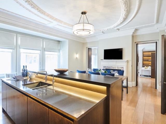 An exceptional three bedroom, north west facing, lateral apartment set within a Victorian red brick, Grade II listed building in the heart of Mayfair