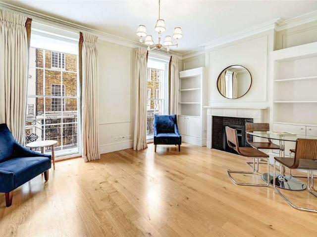 An exceptional maisonette with roof terrace on the first, second and third floors of a white stucco period conversion in this pretty cobbled street