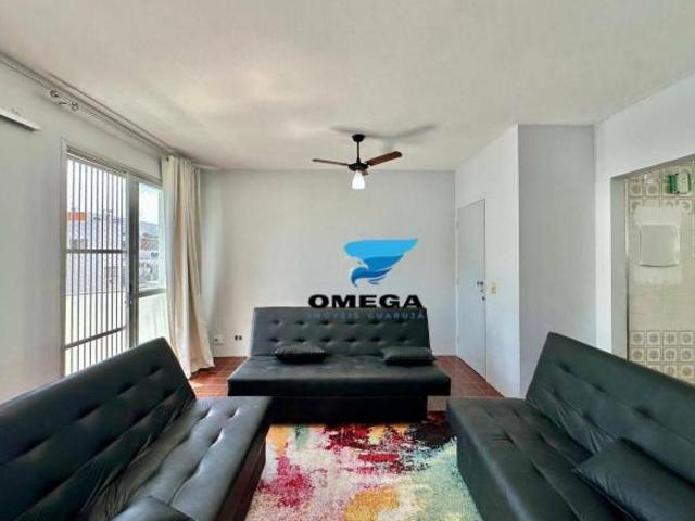 Apartamento com vista parcial para mar à venda na praia das Pitangueiras no Guarujá I Omega Imoveis