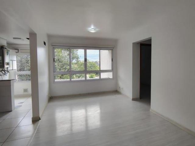 Apartamento de 2 dormitórios, living, cozinha planejada, área de serviço, banheiro social e 1 vaga d