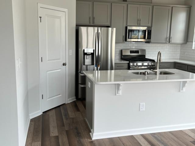 Beautiful end unit townhome in Apex, with features like an open kitchen, fireplace, back deck, 2 car garage, and spacious bedrooms. Great location close to shopping and more. Swimming Pool is shared by the community and administered by the HOA.