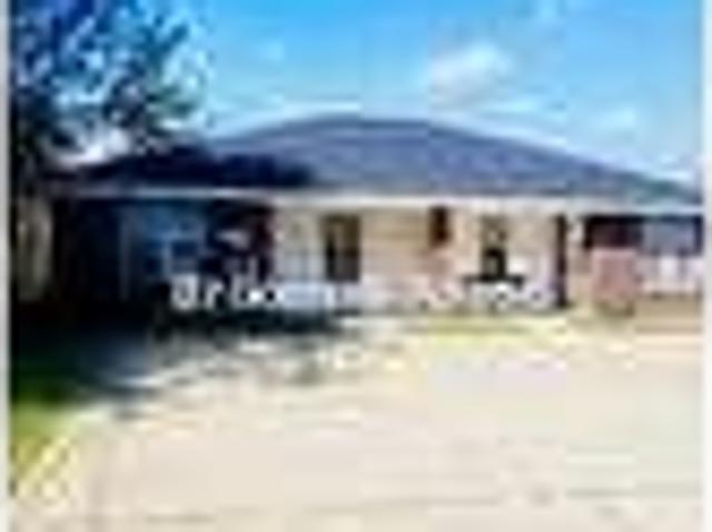 Brick duplex with covered front porch and back patio