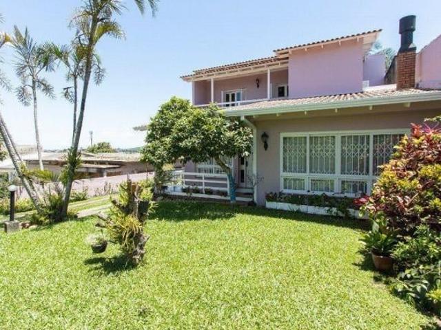 Casa com 4 quartos, suíte, churrasqueira, lareira, garagem coberta e lindo jardim
