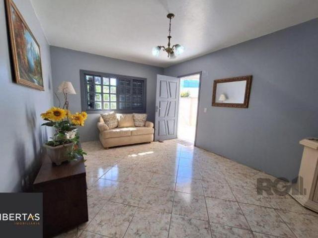Casa com 3 dormitórios, suíte, lareira, Jardim Algarve em Alvorada RS
