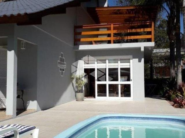 Casa de Alto Padrão 378 m², totalmente cercada, com piscina e jardim, localizada em Morro Reuter