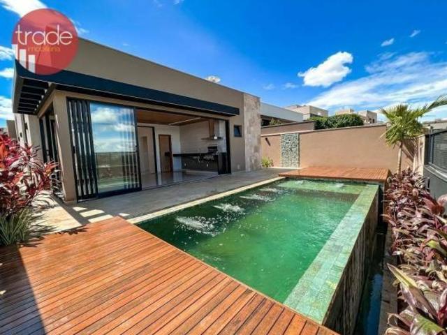 Casa térrea em condomínio fechado com 03 suítes e piscina borda infinita
